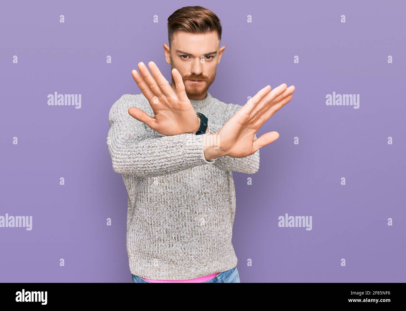 Young redhead man wearing casual winter sweater rejection expression ...