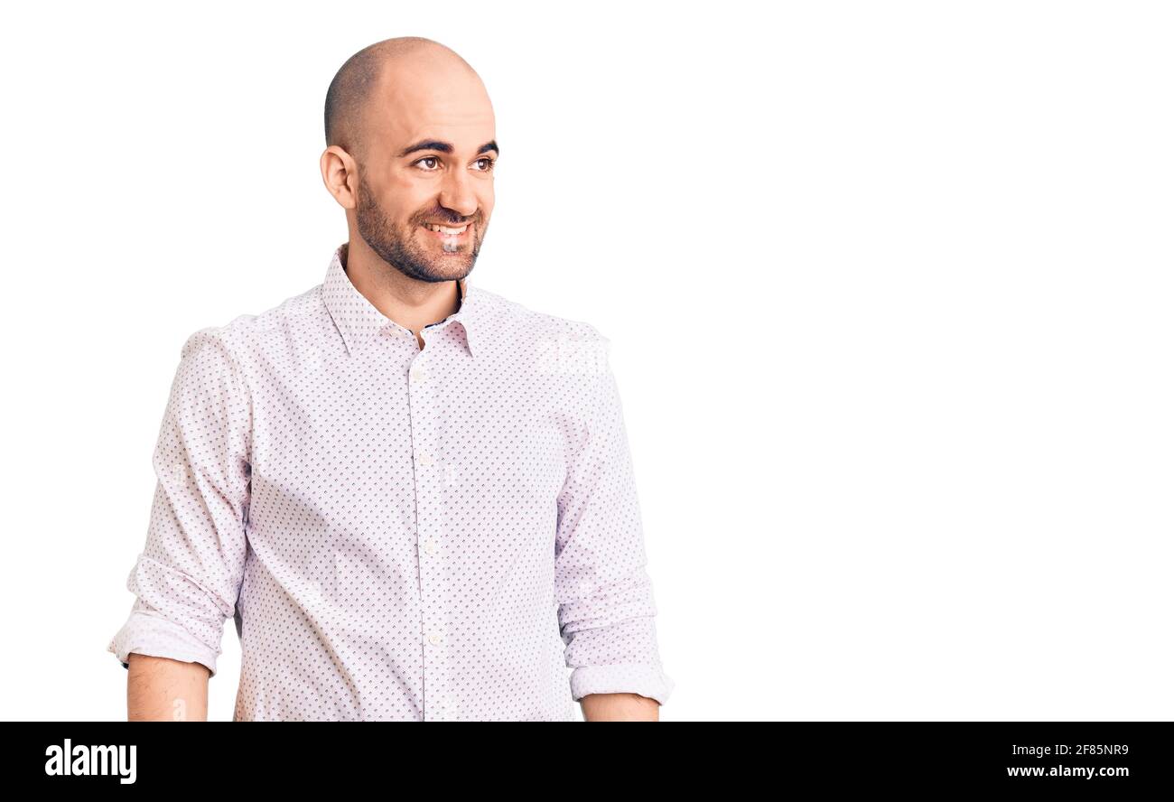 Young handsome man wearing elegant shirt looking away to side with ...