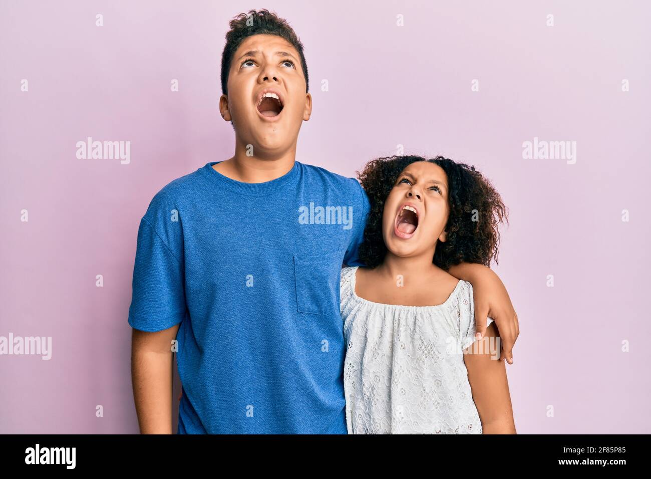 Young hispanic family of brother and sister wearing casual clothes ...
