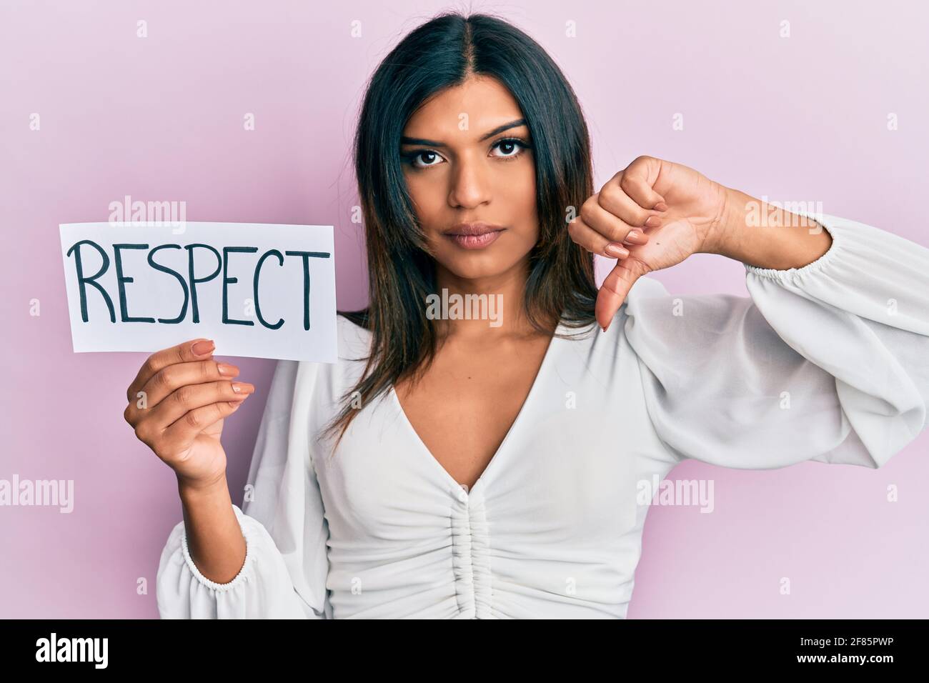 Young latin transsexual transgender woman holding respect message paper ...