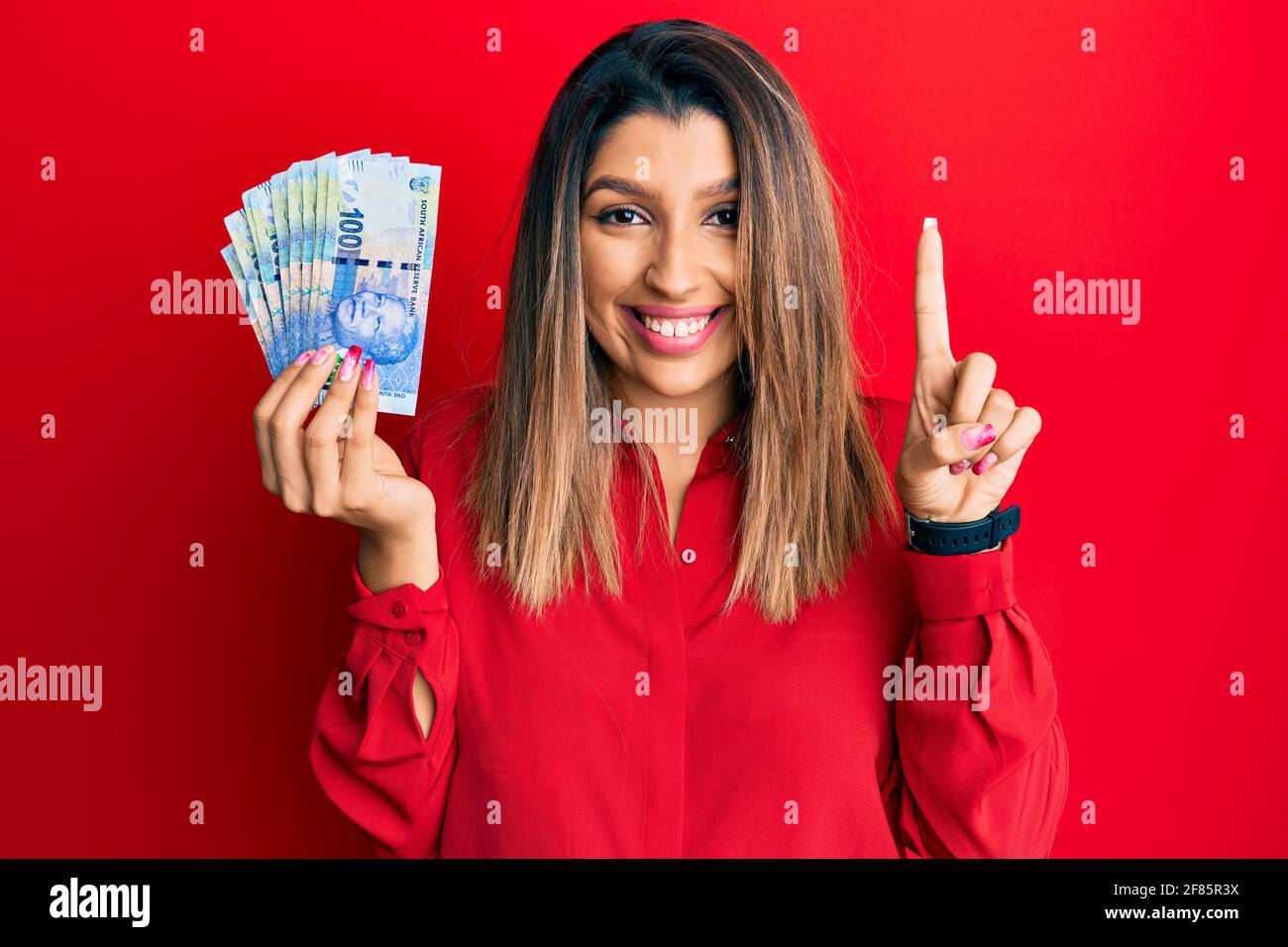 Beautiful brunette woman holding south african 100 rand banknotes ...