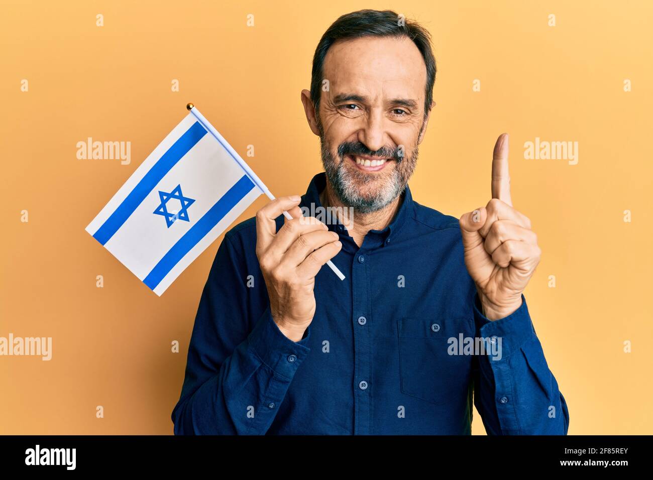 Middle age hispanic man holding israel flag smiling with an idea or ...
