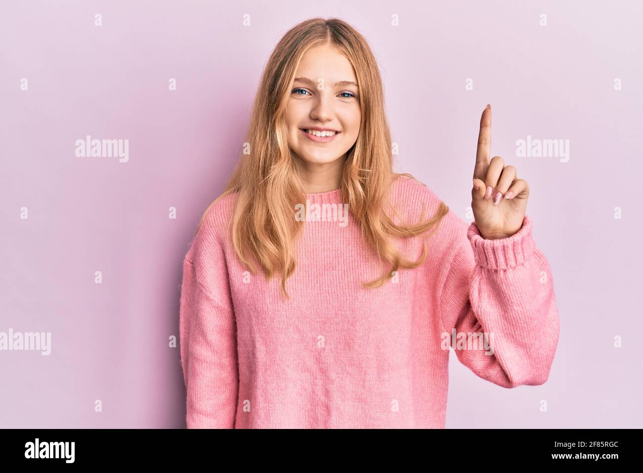 Beautiful young caucasian girl wearing casual clothes showing and ...
