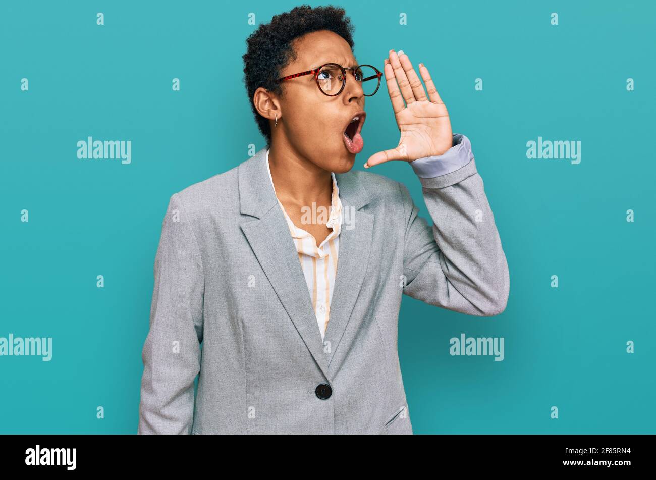 Young african american woman wearing business clothes shouting and ...