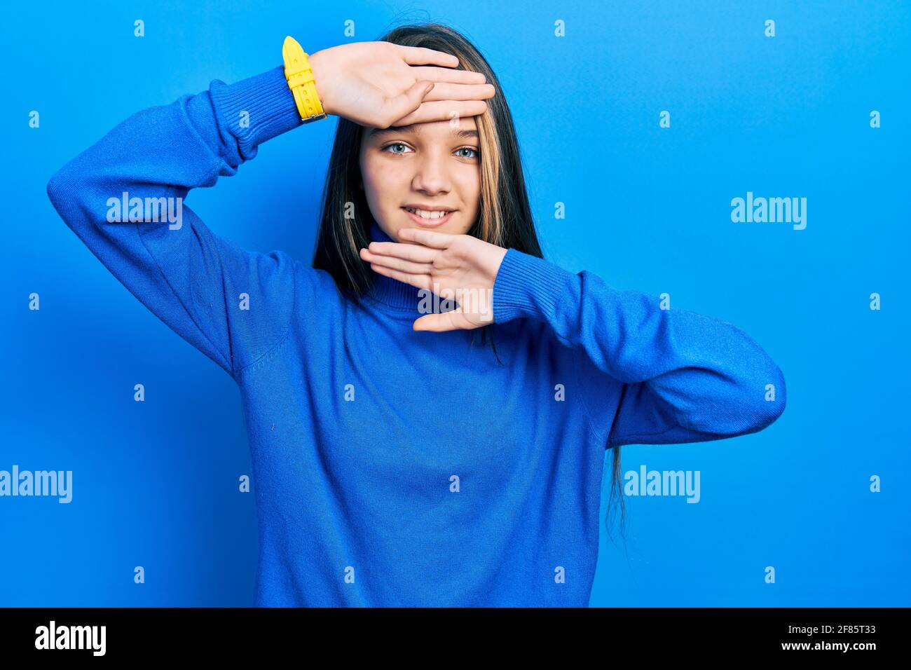 Young brunette girl wearing turtleneck sweater smiling cheerful playing ...