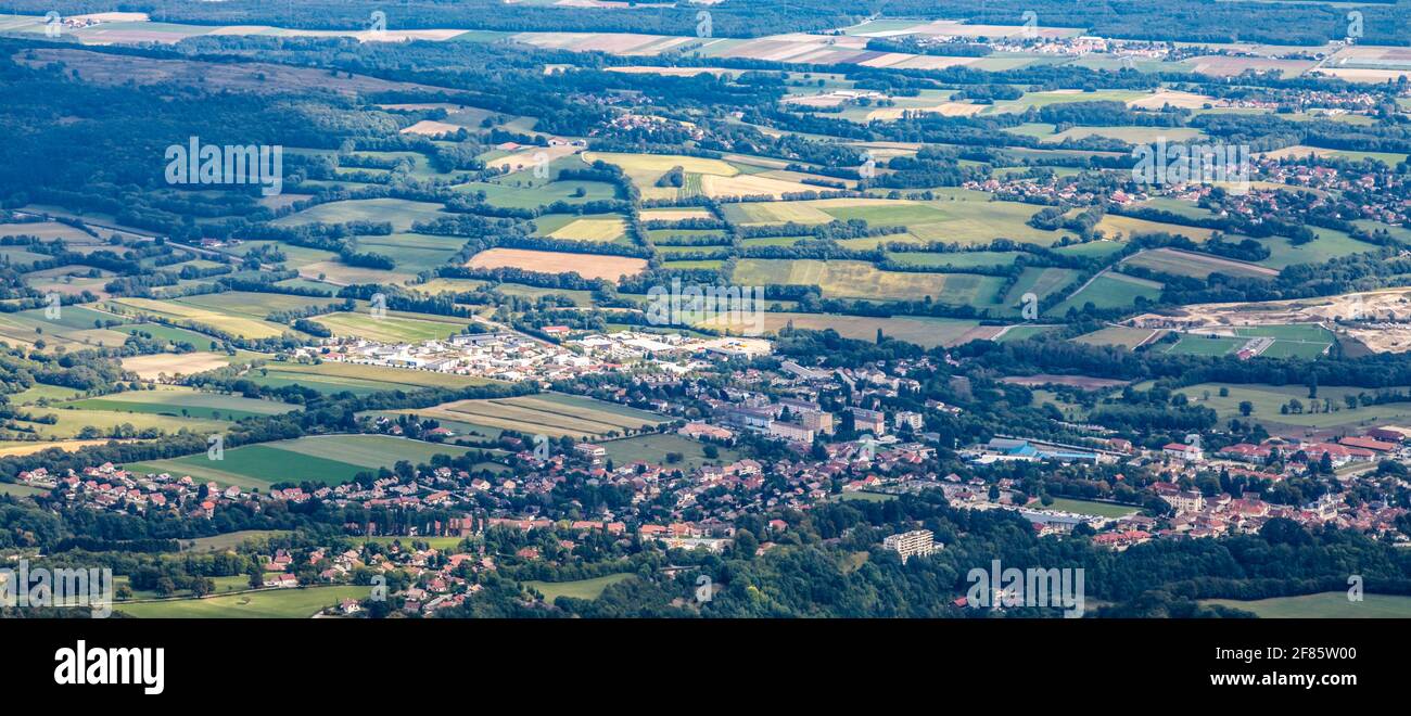 Aerial view of rural localities at the base of Jura Mountains in France ...