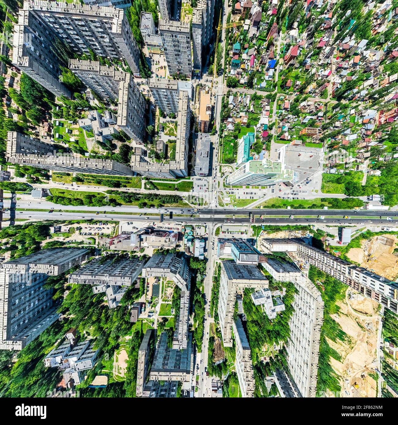 Aerial city view with crossroads and roads, houses, buildings, parks ...