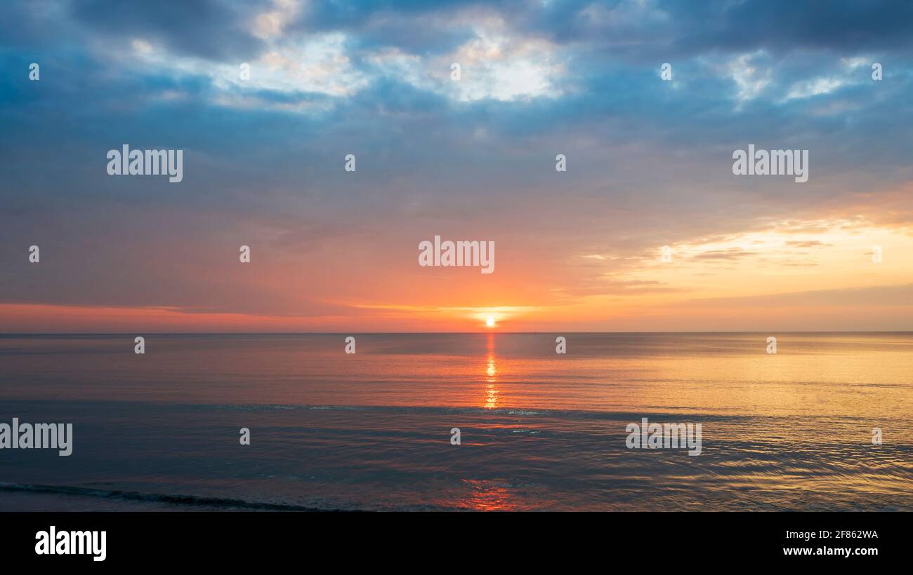Beautiful sunset over the clam sea with cloud sky background. Sunset ...