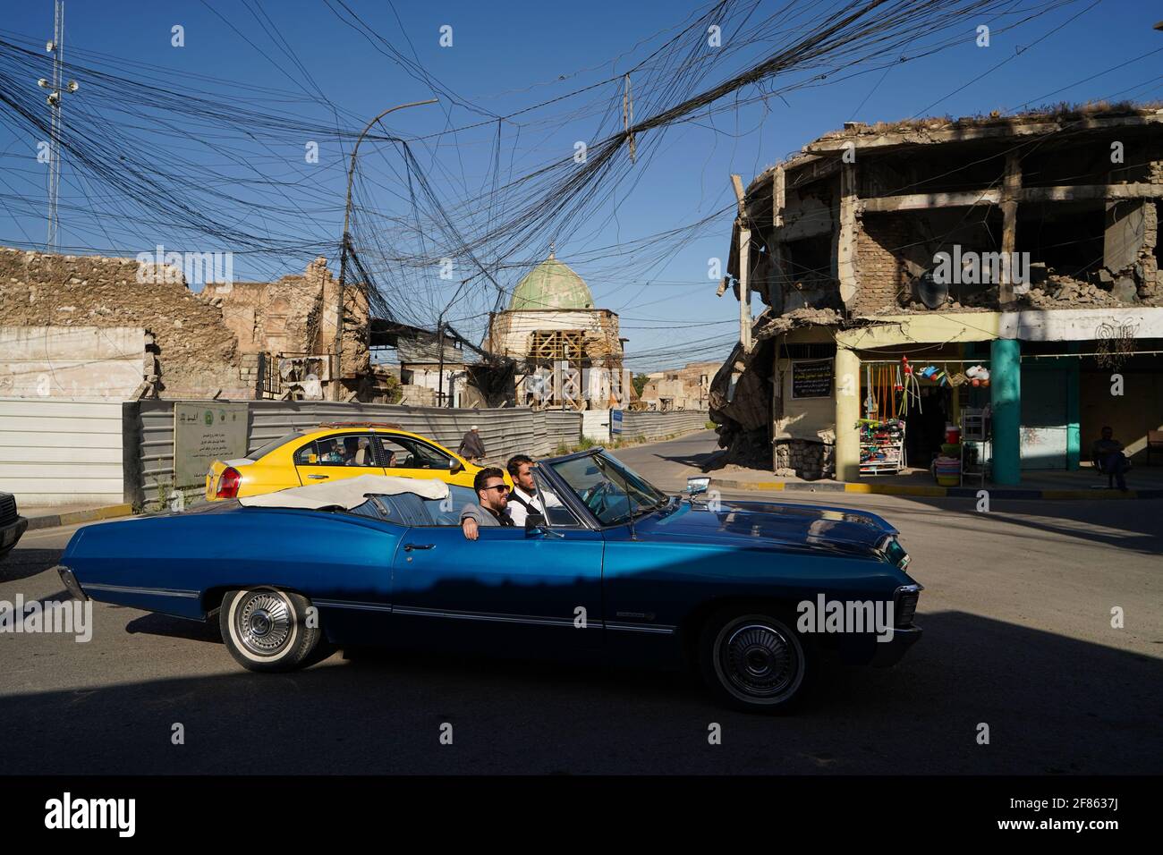 Mosul, Iraq. 11th Apr, 2021. A man drives a vintage car near the Al ...