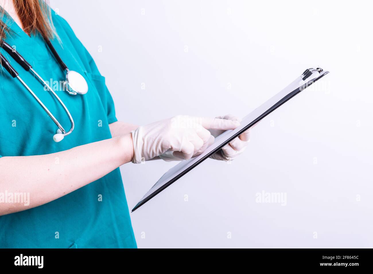 Selective view of female doctor's hand pointing a piece of information ...