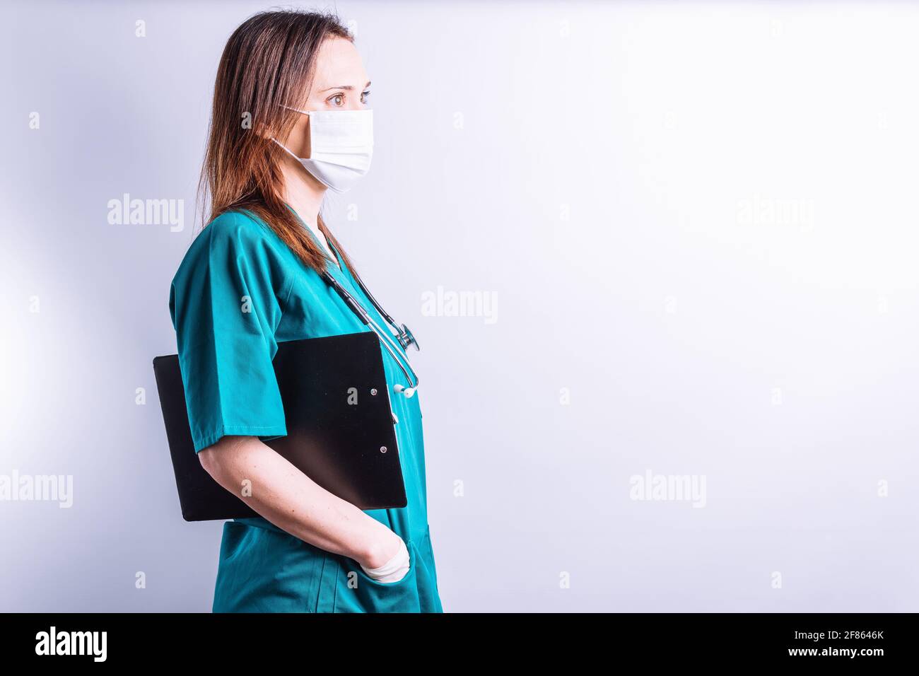 Hospital doctor on white background with stethoscope report under arm ...