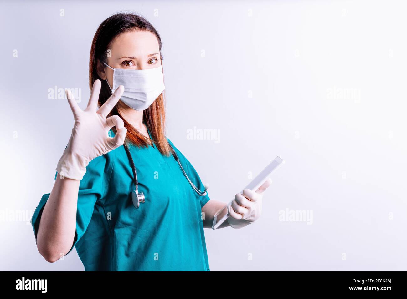 Hospital doctor making an approval symbol with hand with stethoscope ...