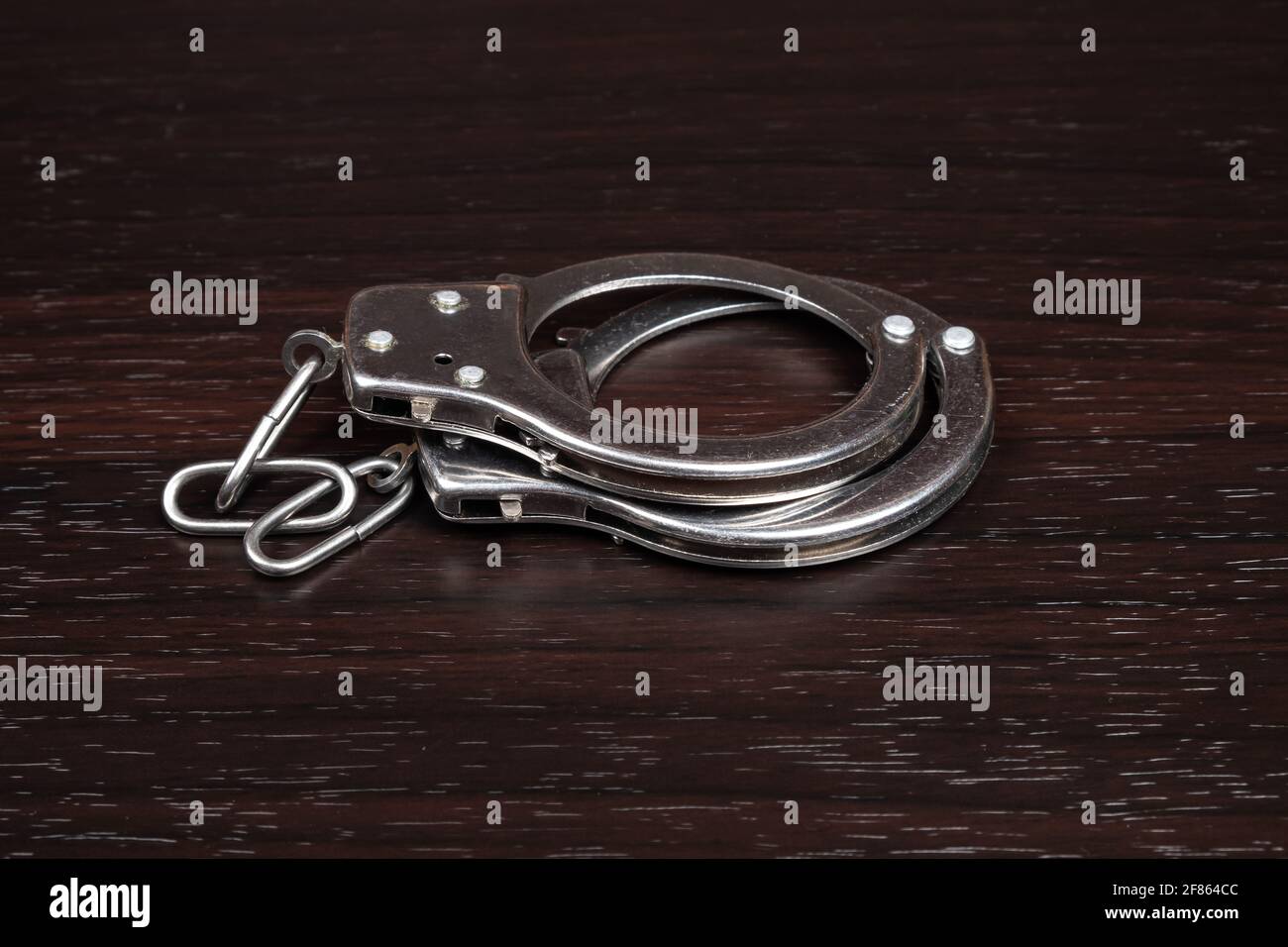 handcuffs on a dark background closeup,crime arrest Stock Photo - Alamy