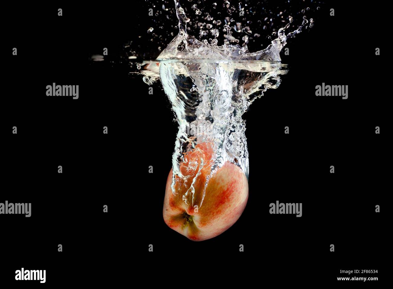 ripe red apple fell into the water with splashes Stock Photo - Alamy