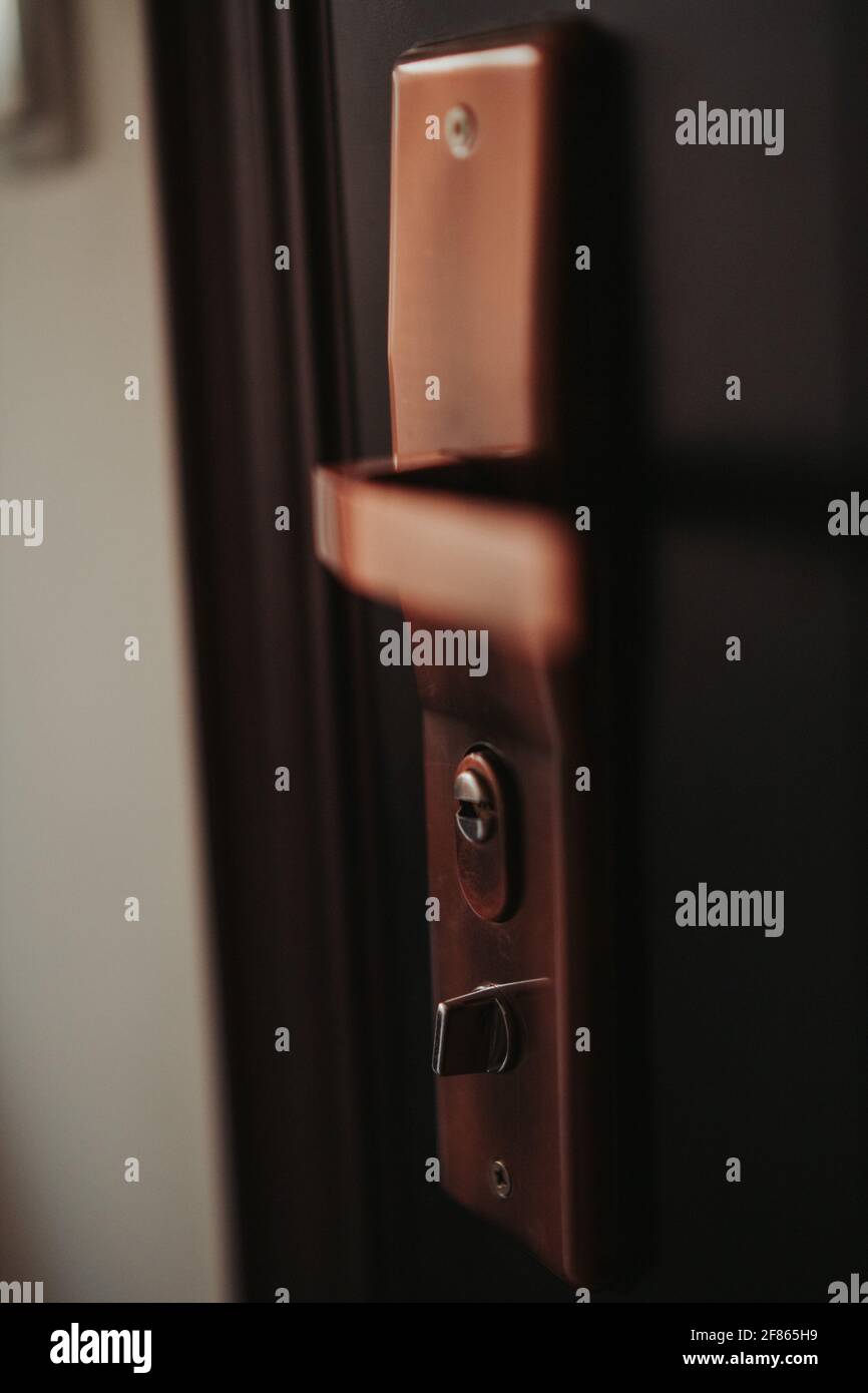 Vertical shot of a metal door lock on a blurred background Stock Photo ...