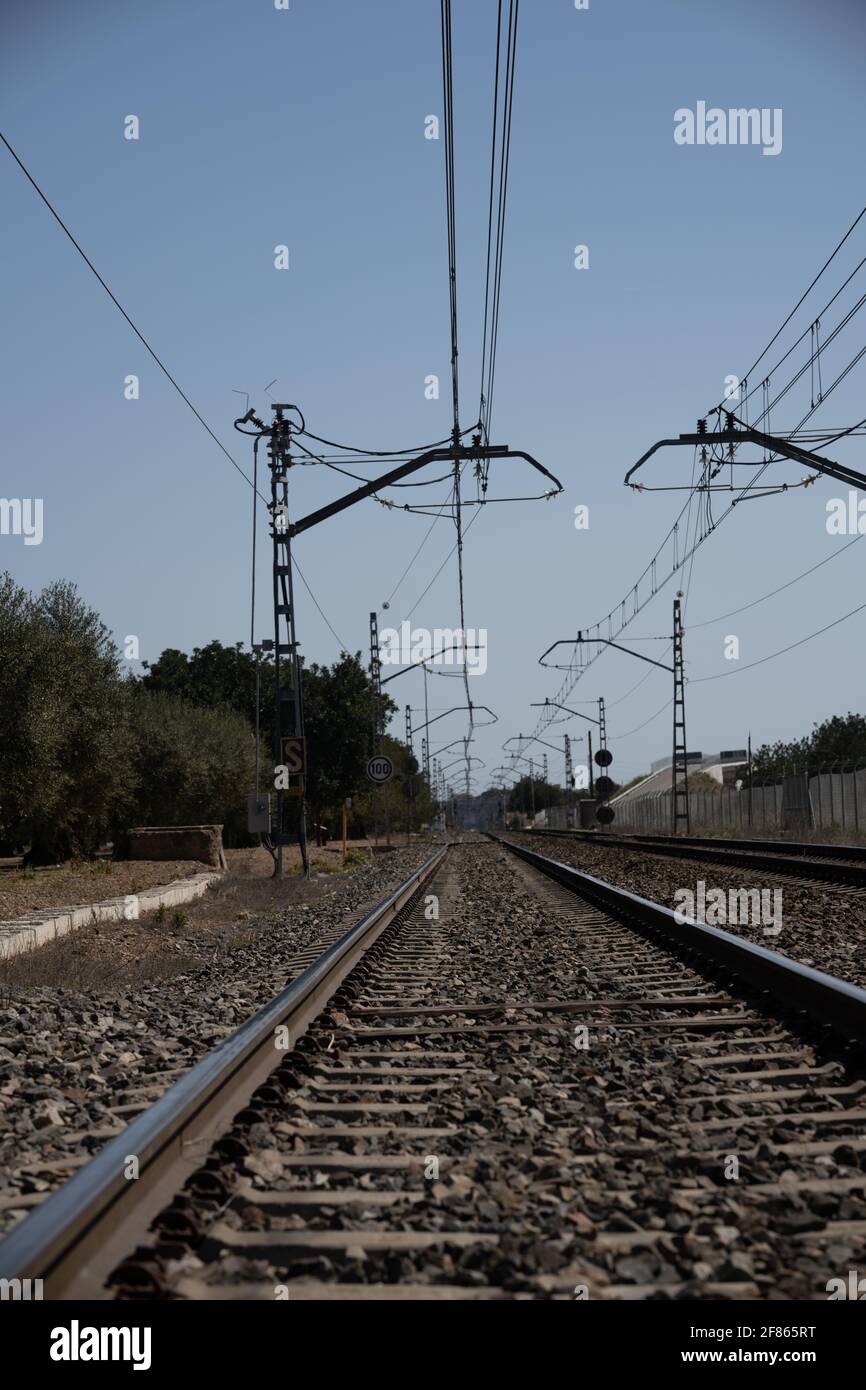 Vertical shot of railway tracks with overhead electric wires Stock ...