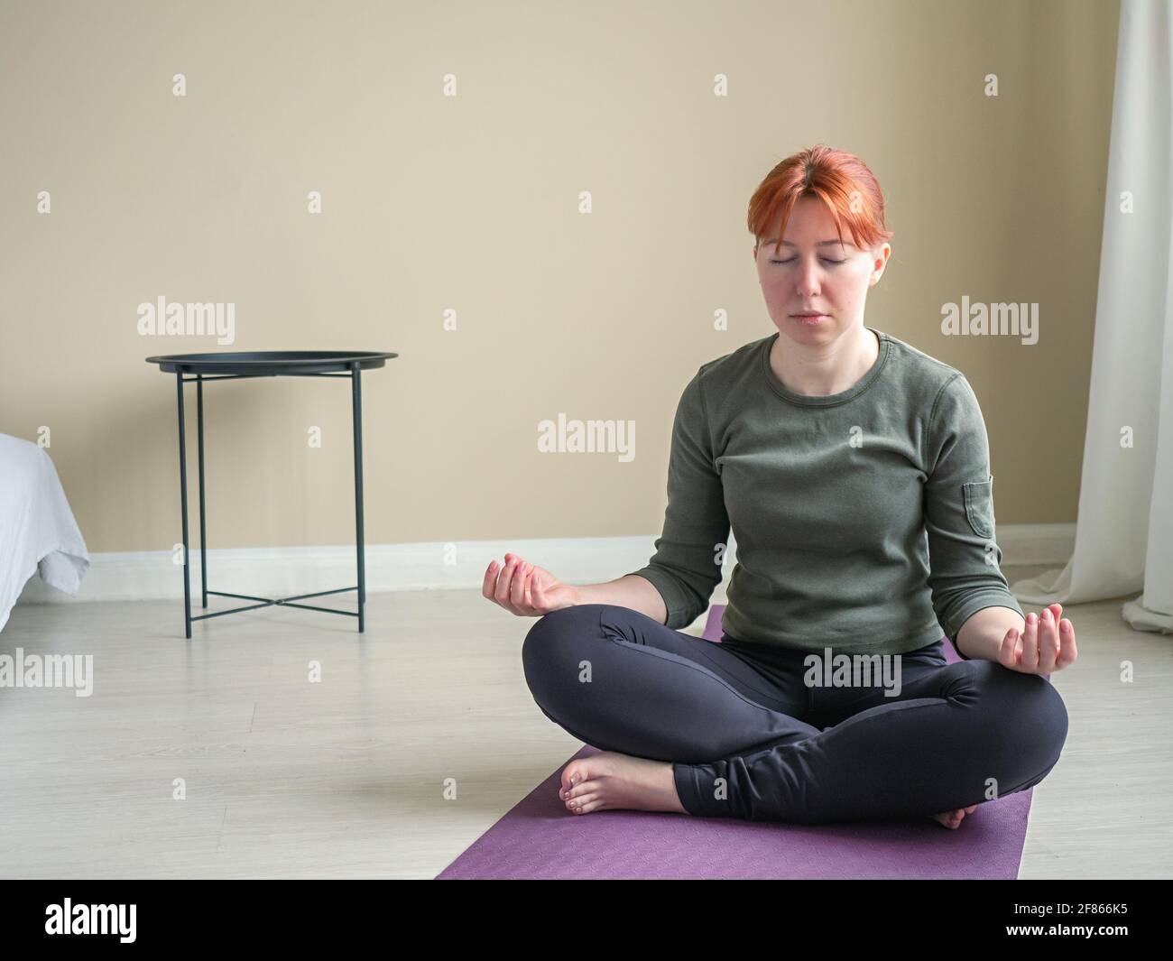 Woman sitting on floor in posture of meditation. Girl doing meditative ...