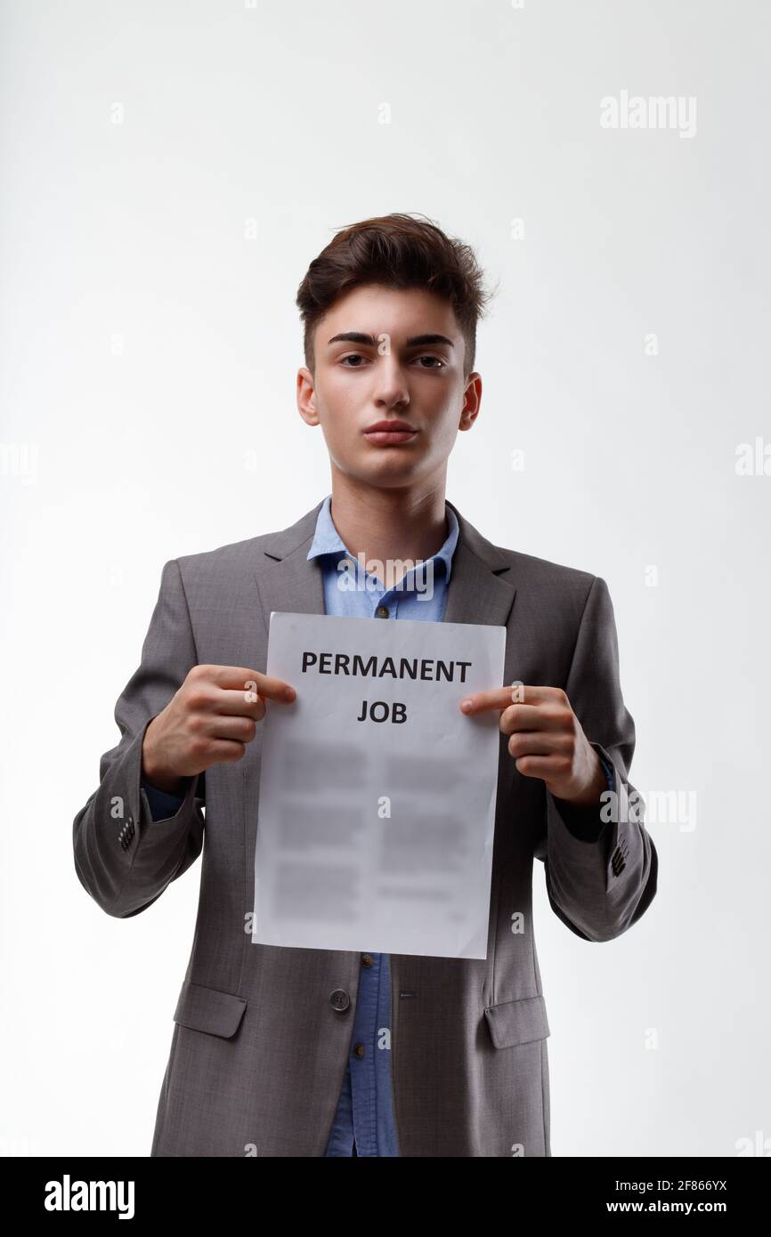 Smart young graduate in a jacket seeking a Permanent Job holding up a ...
