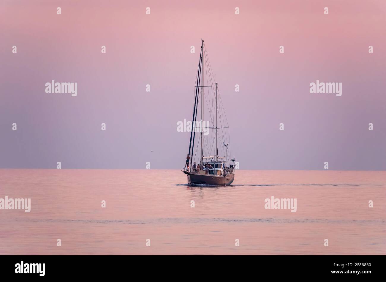 Sailing yacht in the blue sea during beautiful pink sunset. A yacht in ...