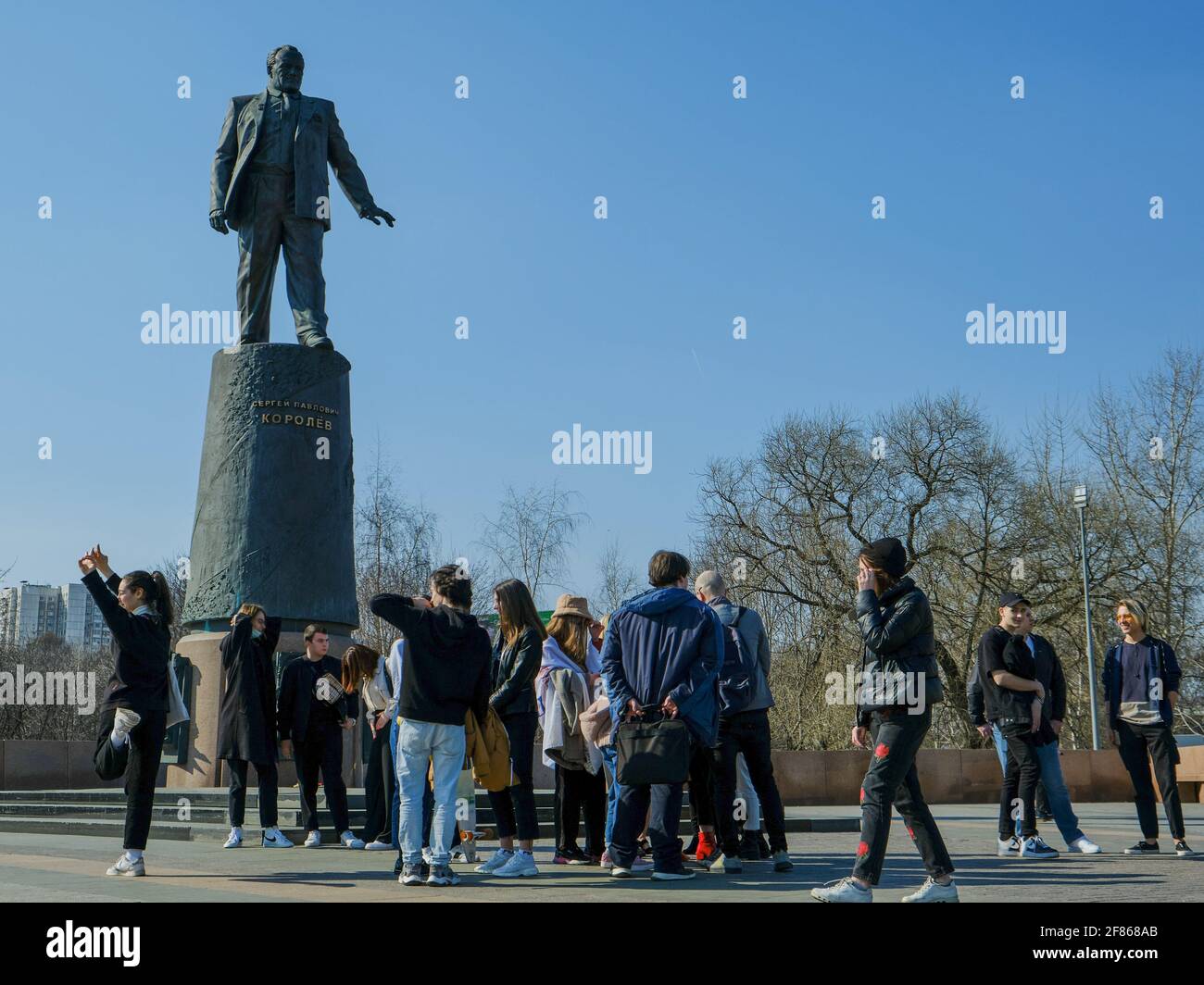 Visitors pose for a photo near the monument to Soviet rocket designer ...