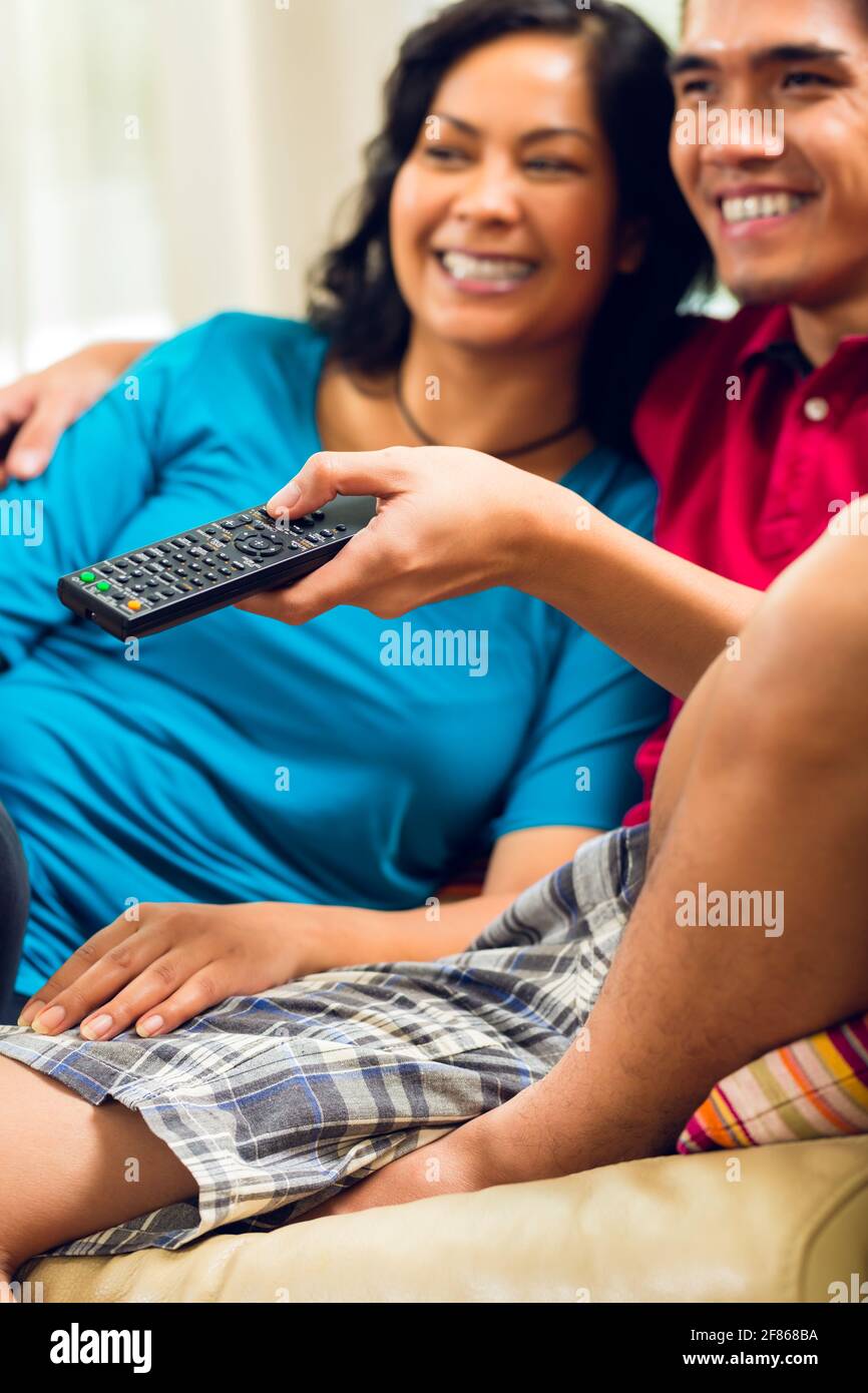 Asian people watching together television or tv and having fun Stock ...