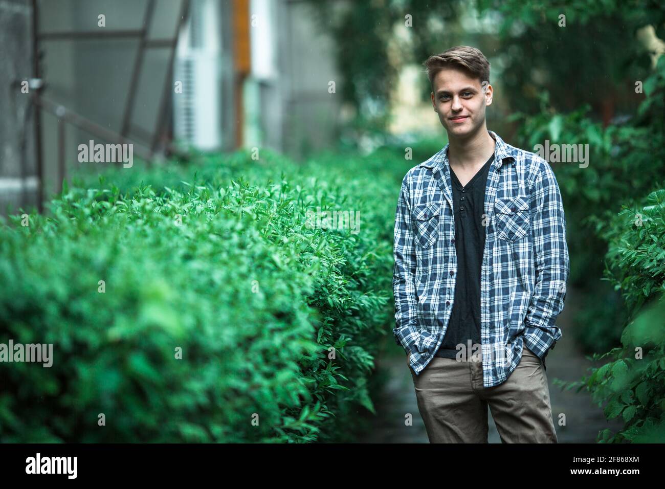 Charming young man stands outdoors Stock Photo - Alamy