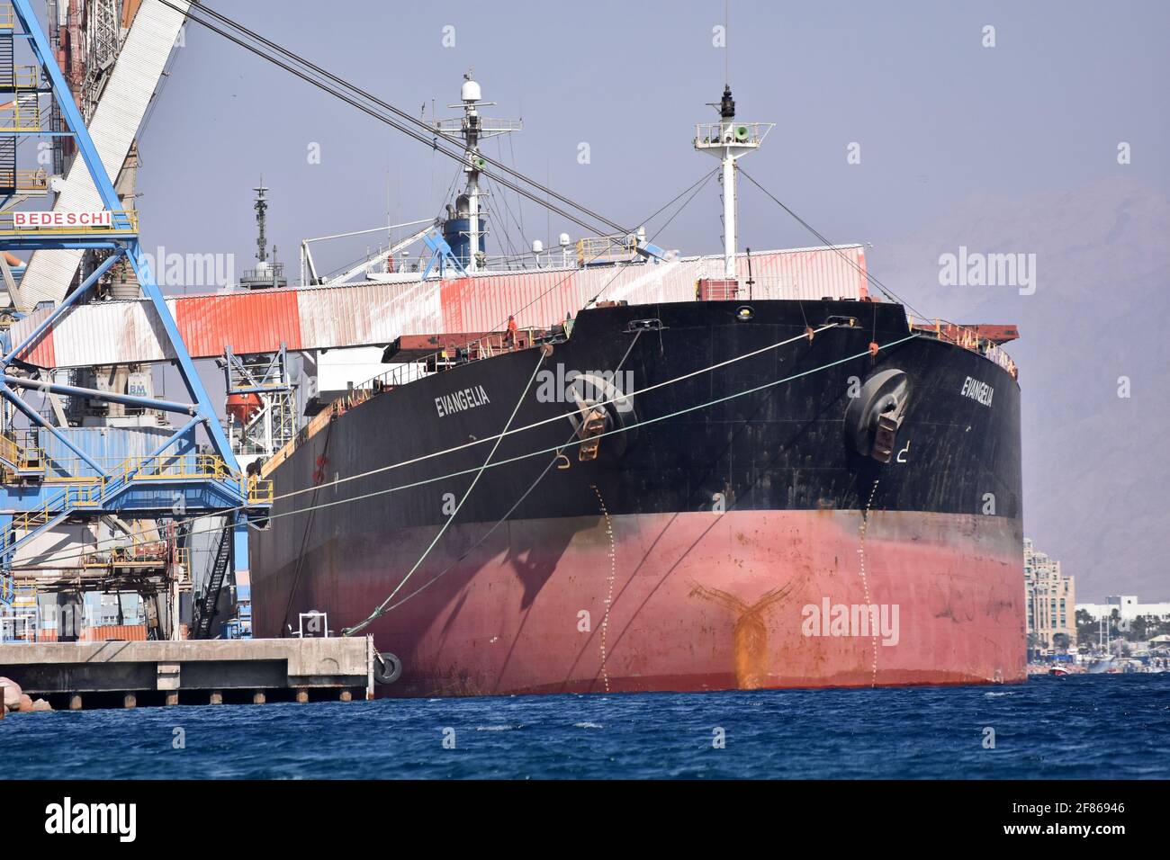 EILAT, ISRAEL - Mar 29, 2021: cargo ship loading cargo in Eilat bay ...