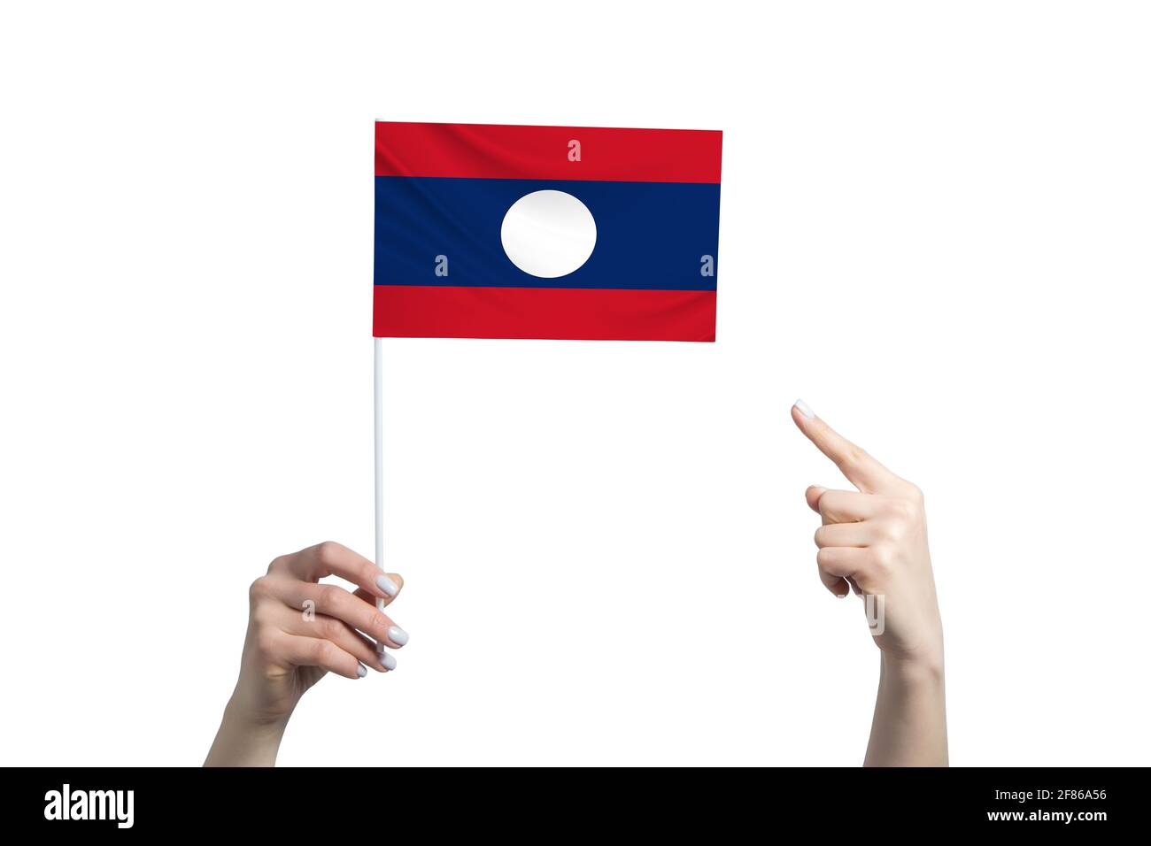 A beautiful female hand holds a Laos flag to which she shows the finger ...