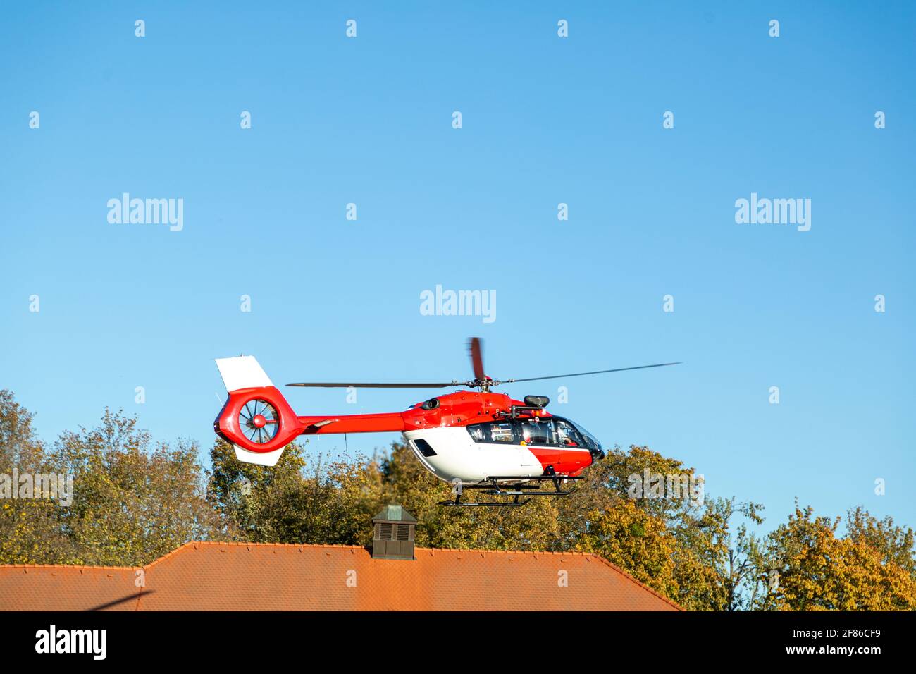 Fire fighter helicopter flying in the air over the city Stock Photo - Alamy
