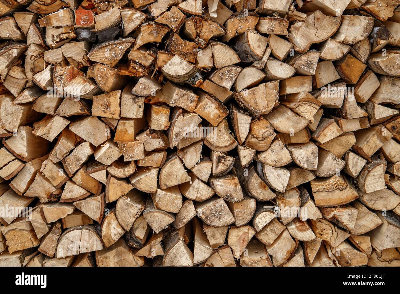 Split logs are stacked in smooth pile of firewood Stock Photo - Alamy