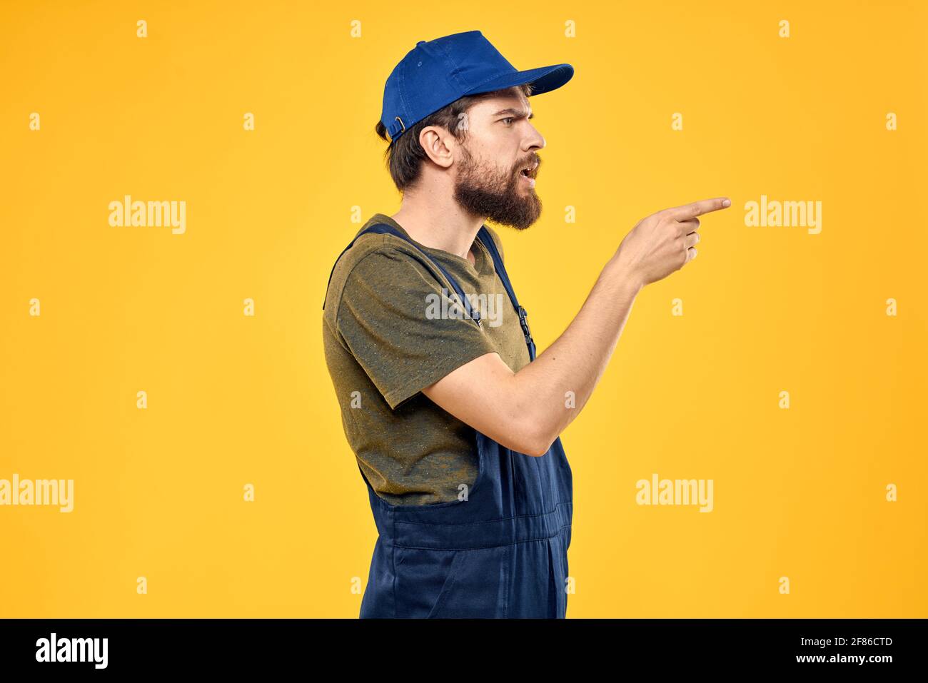 working man in uniform professional delivery service yellow background ...