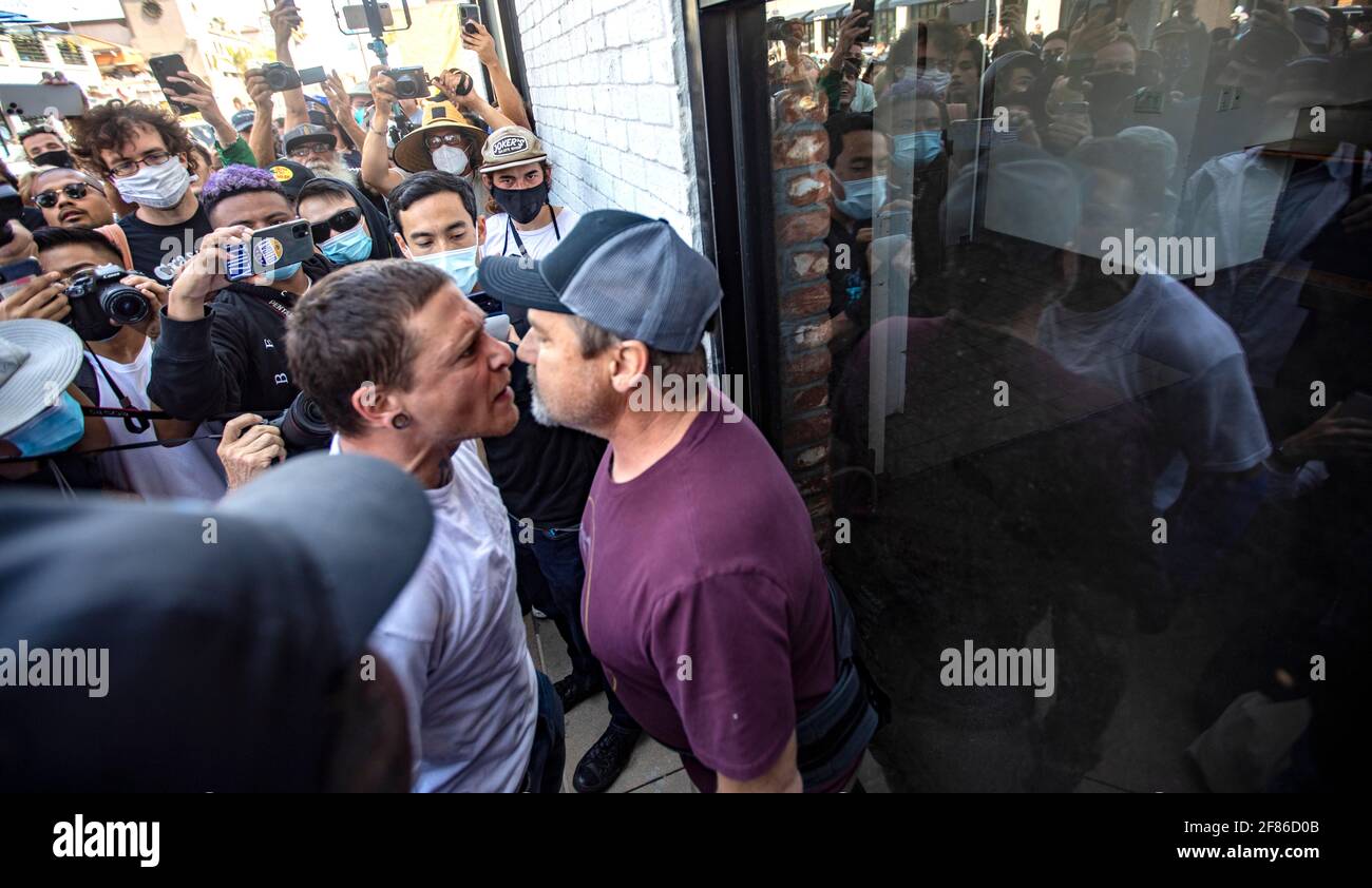 Los Angeles, California, USA. 11th Apr, 2021. A crowd gathers as two ...
