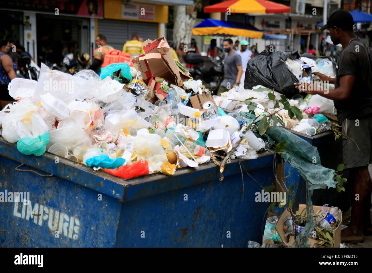 salvador, bahia, brazil - december 16, 2020: man turns over garbage ...