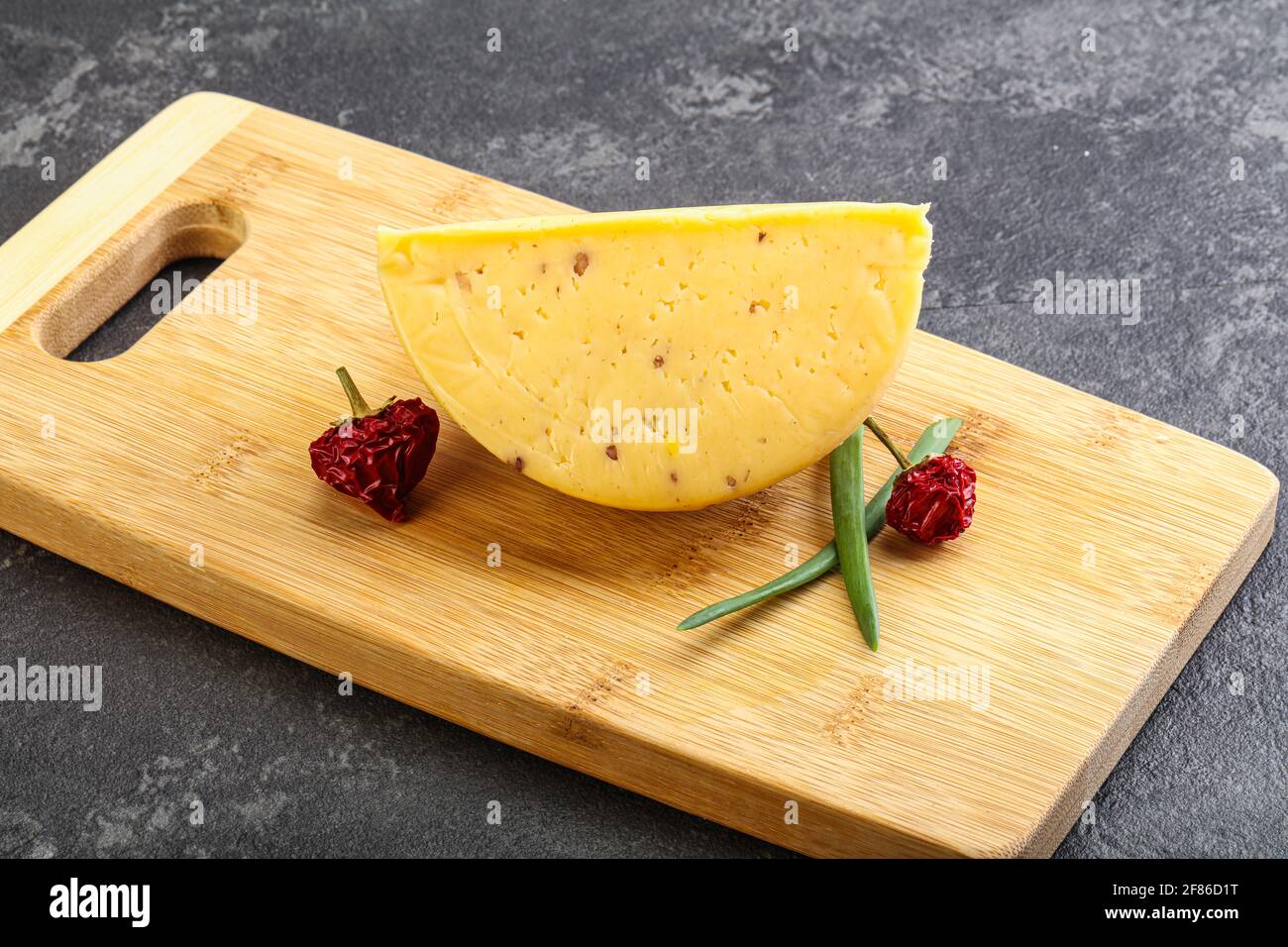 Hard cheese brick with walnut over board Stock Photo - Alamy