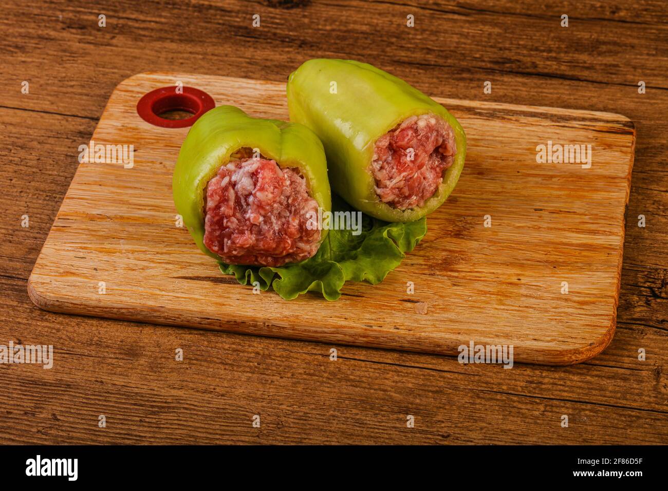 Raw stuffed green bell pepper with meat Stock Photo - Alamy
