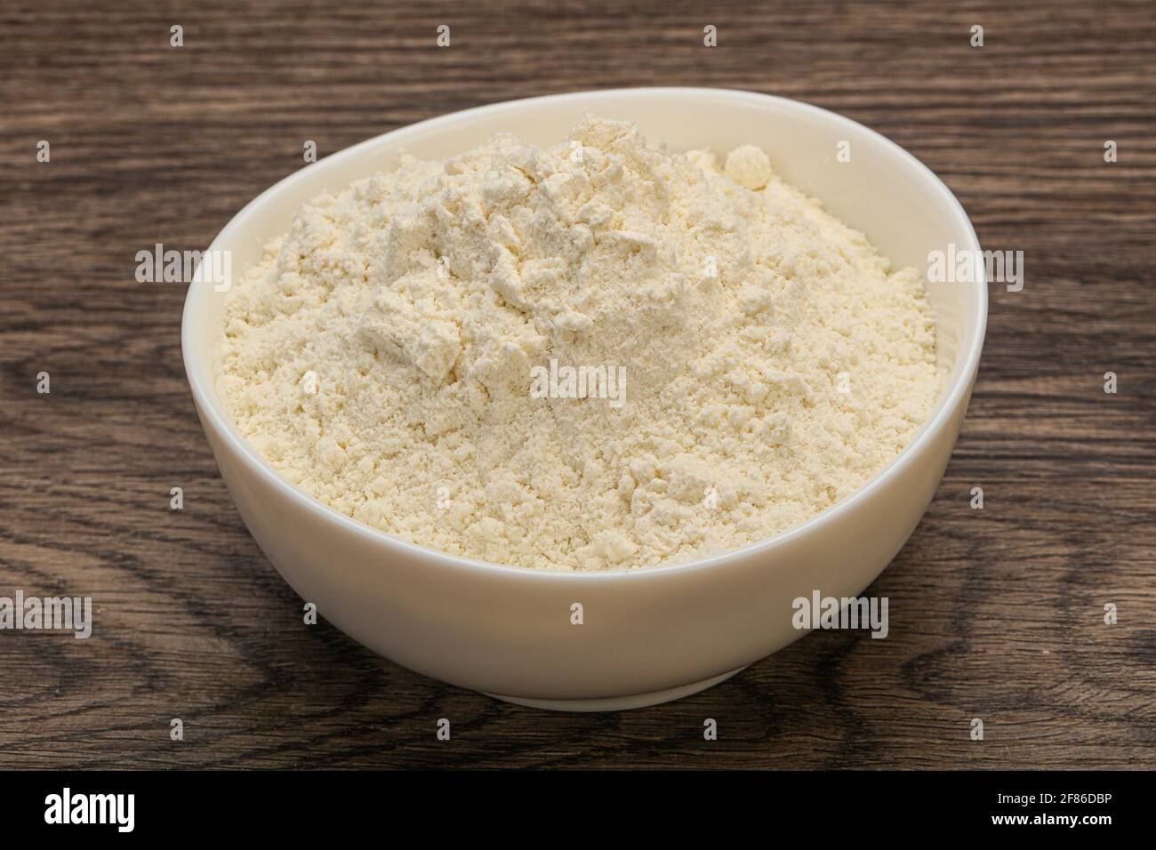 Wheat flour heap in the bowl for cooking Stock Photo - Alamy