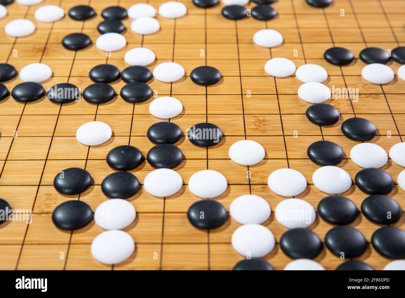 Closeup shot of black and white checkers pieces on the wooden board ...