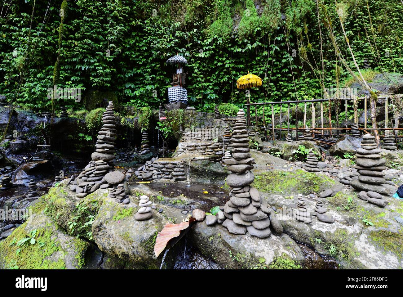 Stacked up stones by a small temple by the Tegenungan waterfall in Bali ...