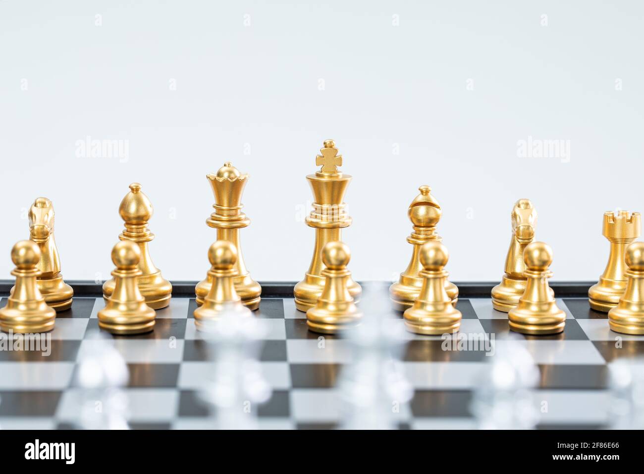 Selective focus shot of golden and silver chess pieces on the checkered ...