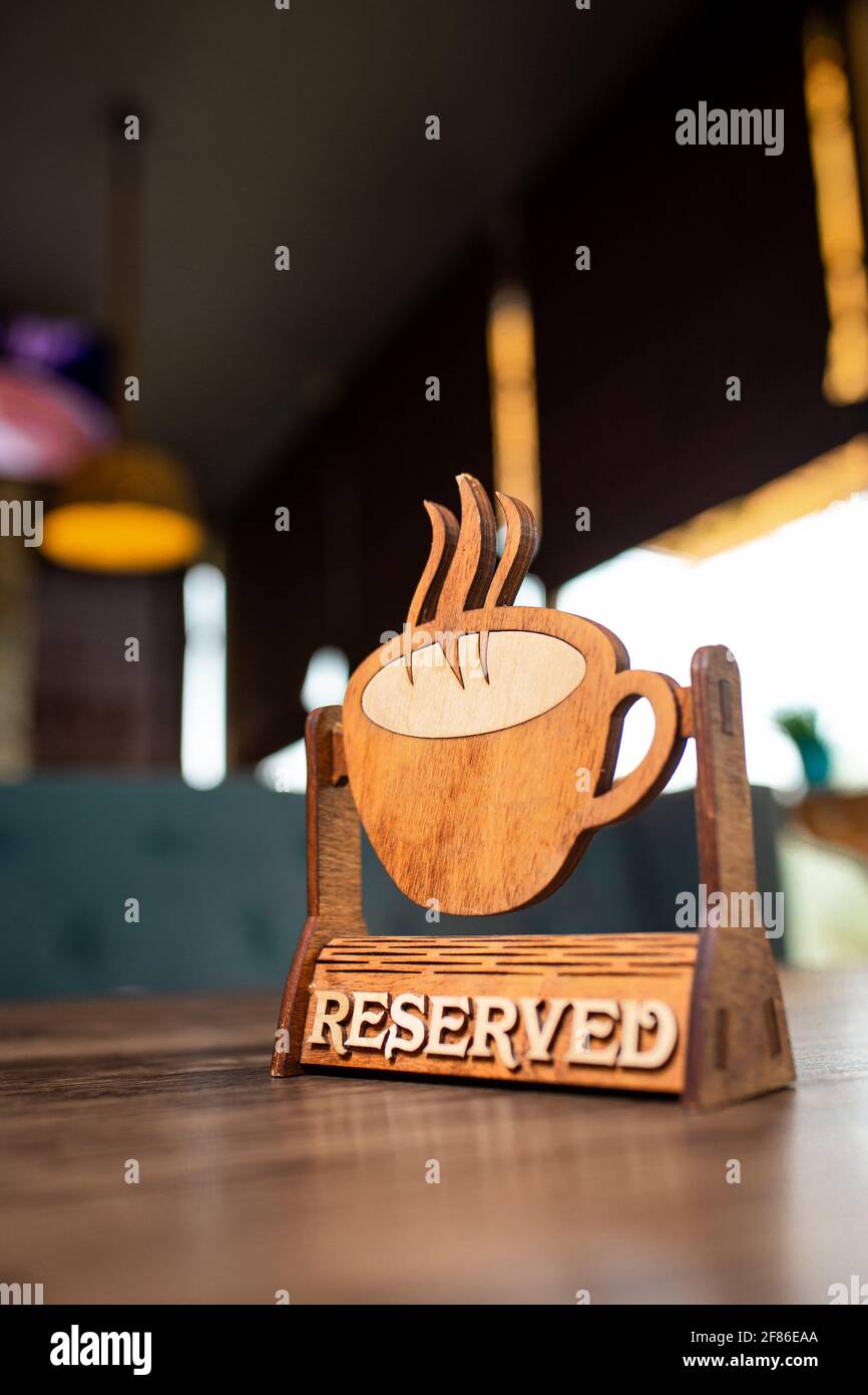 Reserved sign on table in modern restaurant Stock Photo - Alamy