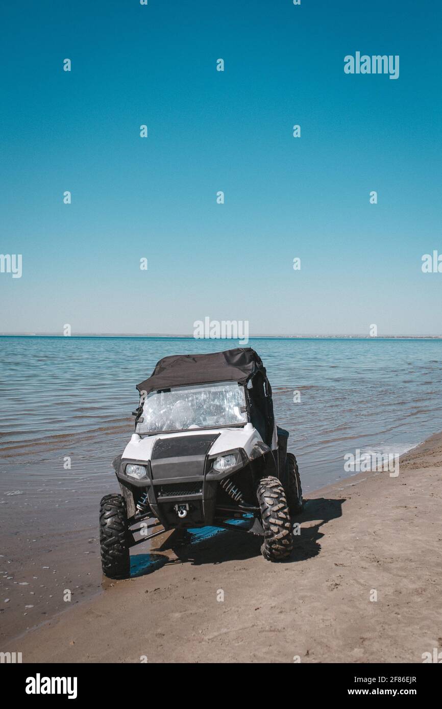 Beautiful nature landscape with ATV near lake shore and sky background ...