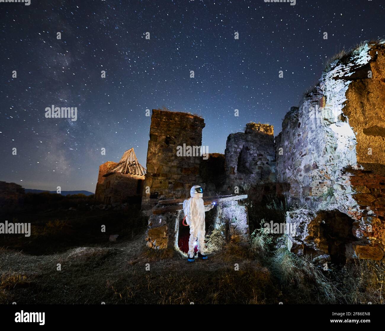 Side view of spaceman in special white suit and helmet research ancient ...