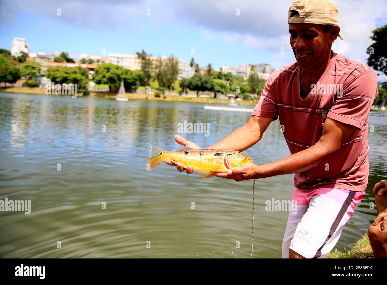 salvador, bahia brazil - december 4, 2020: fisherman shows the tucunare ...