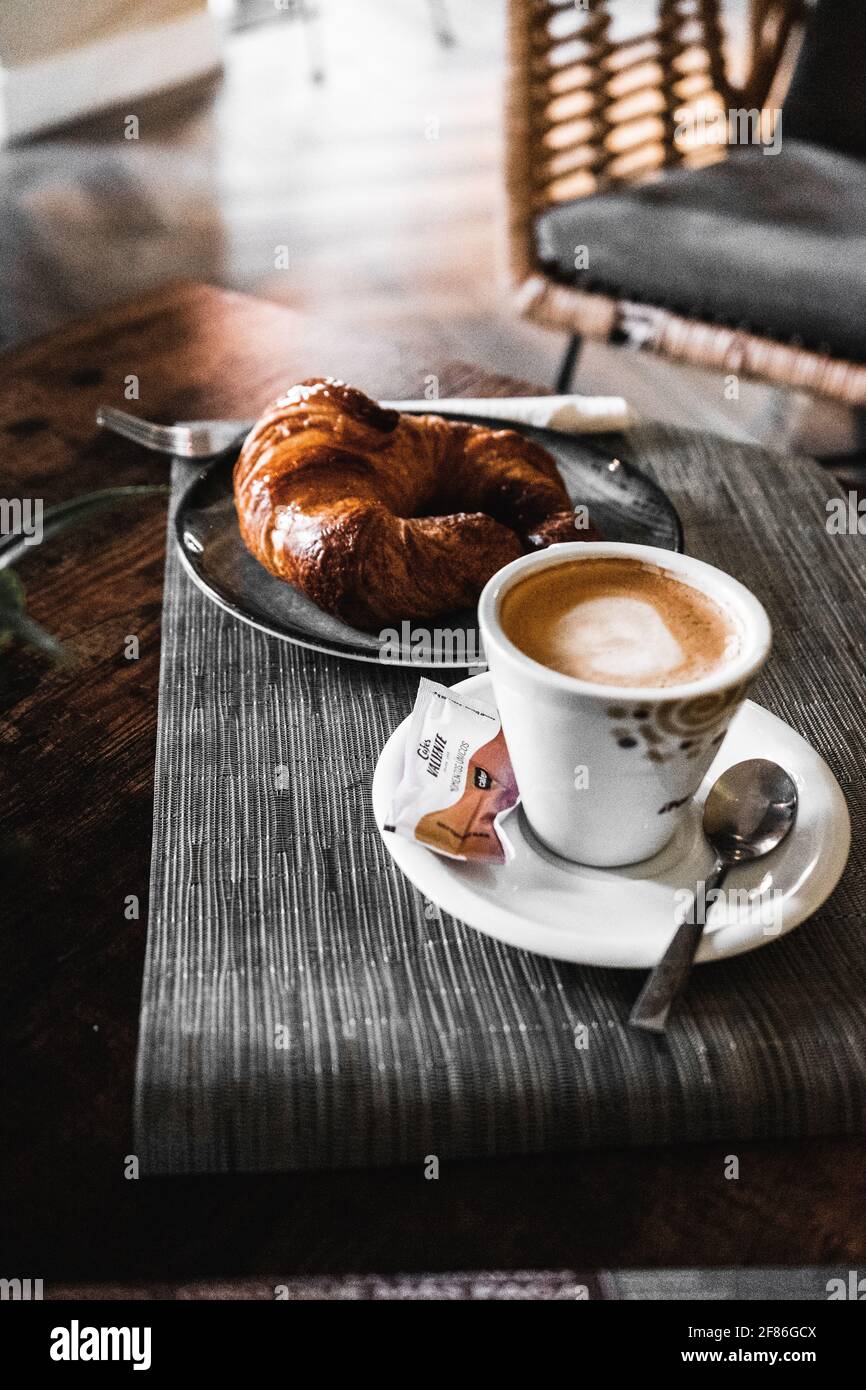 VALENCIA, SPAIN - Mar 31, 2021: Full breakfast at an oak table, with ...