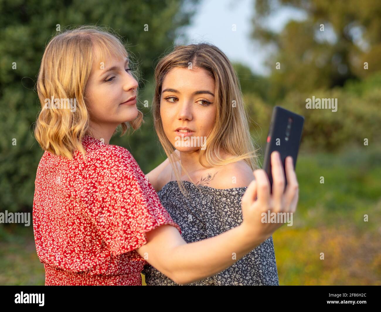 Spanish girls are taking a selfie in the natural background Stock Photo ...