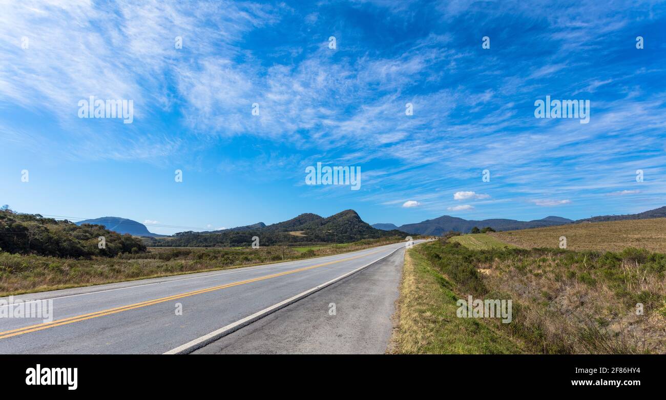 Beautiful country landscape with an asphalt road Stock Photo - Alamy