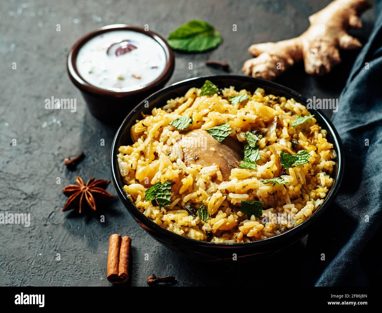 Pakistani food - biryani rice with chicken and raita yoghurt dip ...