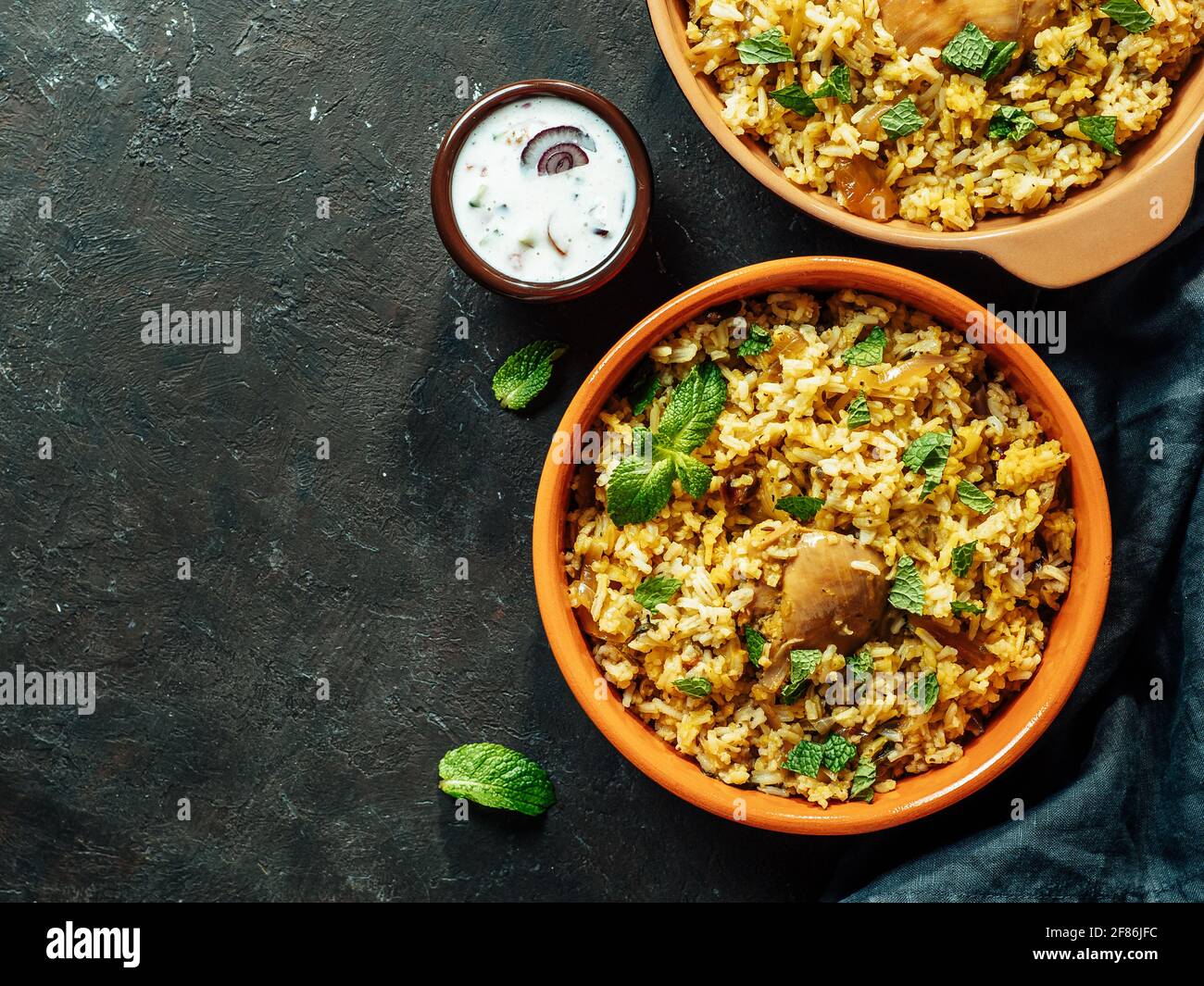 Pakistani food - biryani rice with chicken and raita yoghurt dip ...