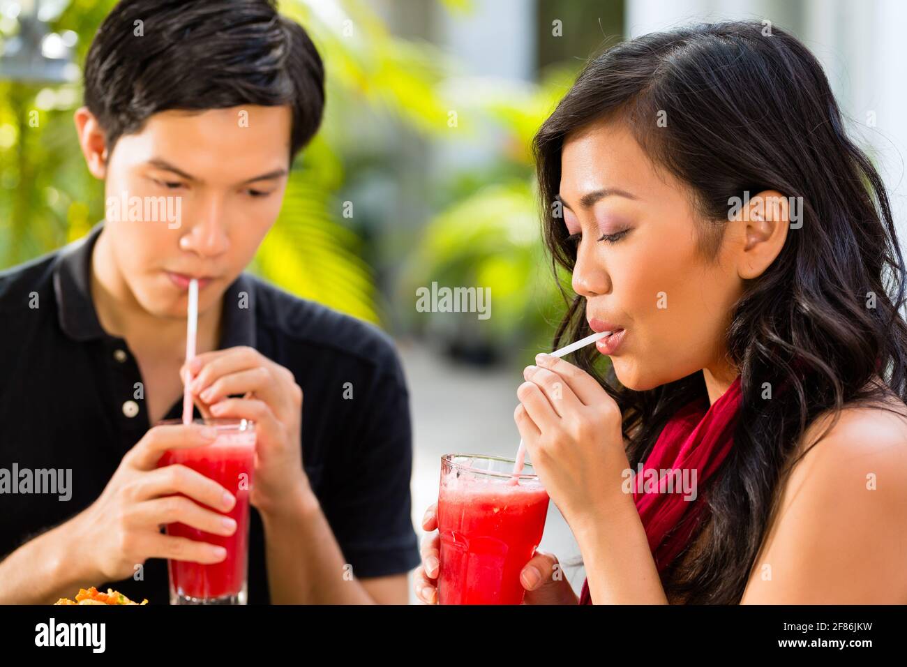 Asian man and woman in restaurant are drinking Cocktails Stock Photo ...