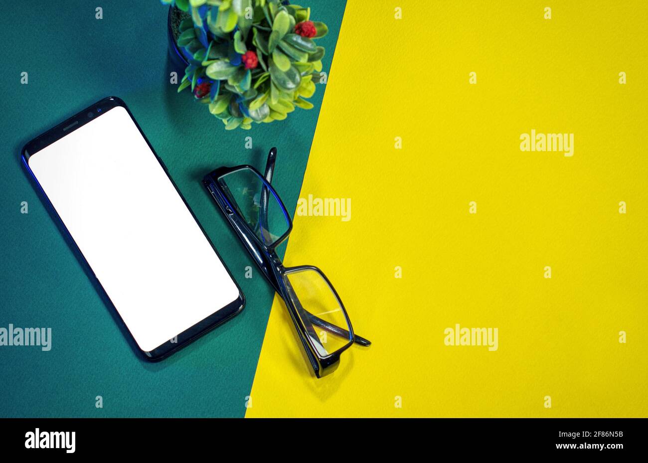 Flat lay technology template with a blank screen smartphone and vibrant ...